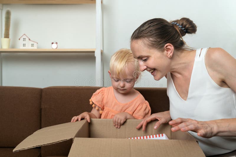 Mom and Daughter Look into a Large Cardboard Box. Package with Gift ...