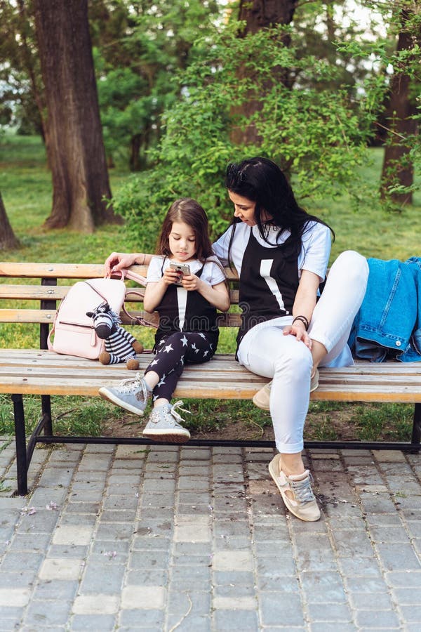 Mom and Daughter Rest on the Bench Stock Photo - Image of active ...