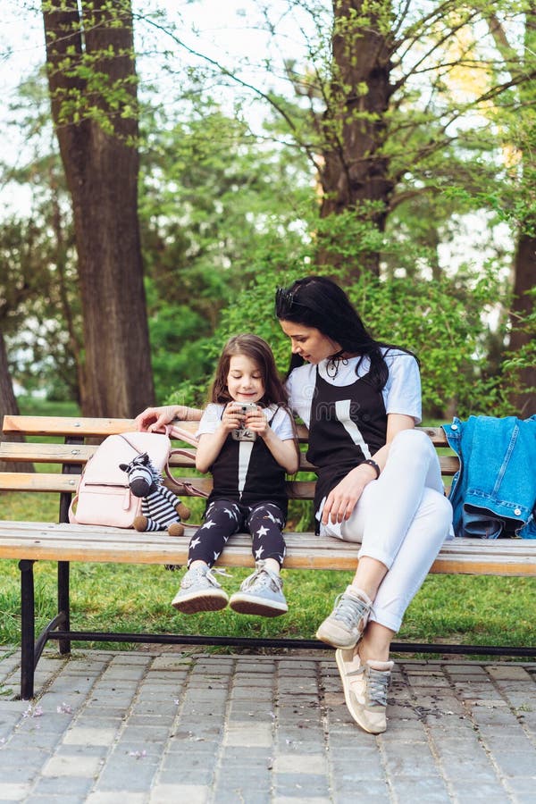 Mom and Daughter Rest on the Bench Stock Image - Image of playful ...
