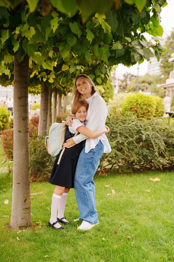 Mom and Daughter in School Uniform on the Lawn Stock Image - Image of ...