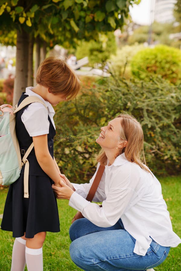 Mom and Daughter in School Uniform on the Lawn Stock Image - Image of ...