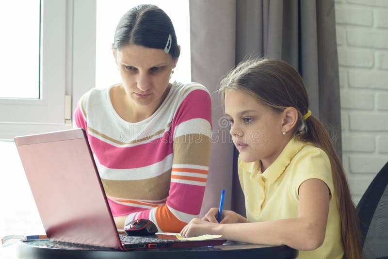Mom and Daughter Solve Homework Using Online Distance Learning Stock ...