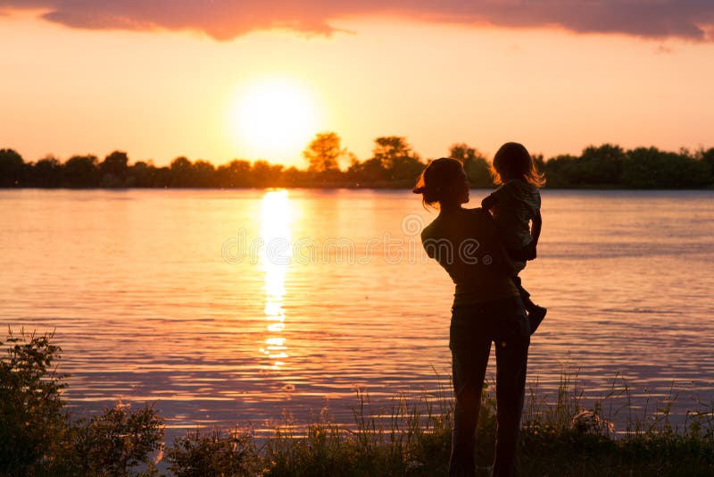 Mom and daughter at sunset stock image. Image of outside - 93804545
