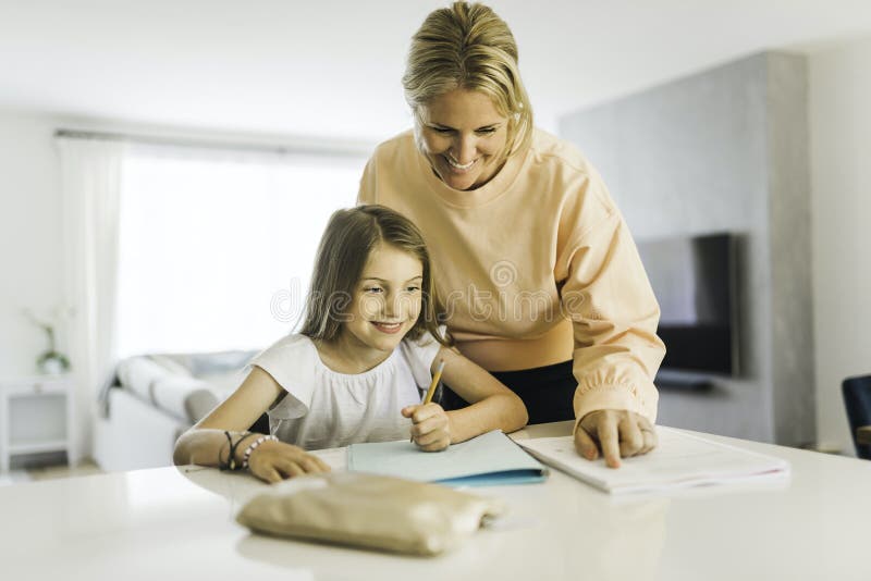 Mom Helping Kid with Homework at Home Stock Photo - Image of pencil ...