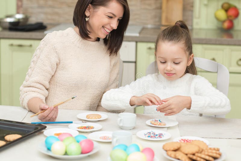 Mom and Her Daughter Baking Together and Decorating the Cookies Stock ...