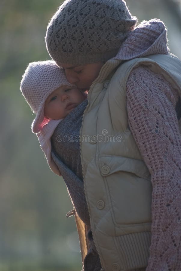 Mom hugging baby outdoors stock image. Image of leaves - 58991577