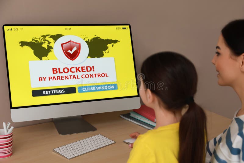 Mom Installing Parental Control on Computer at Table. Child Safety ...