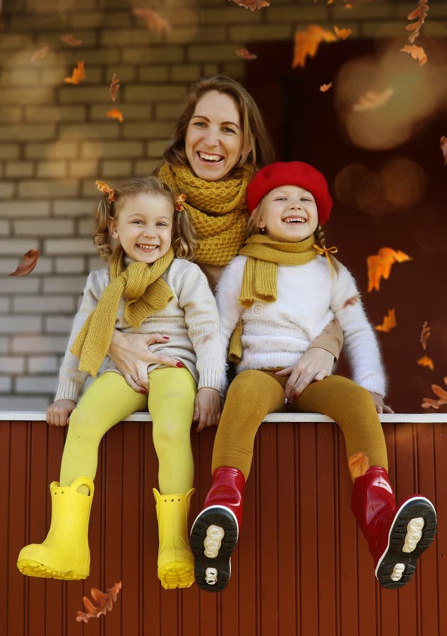 Mom and Little Daughters Laughing in Autumn in Rain Boots Stock Photo ...