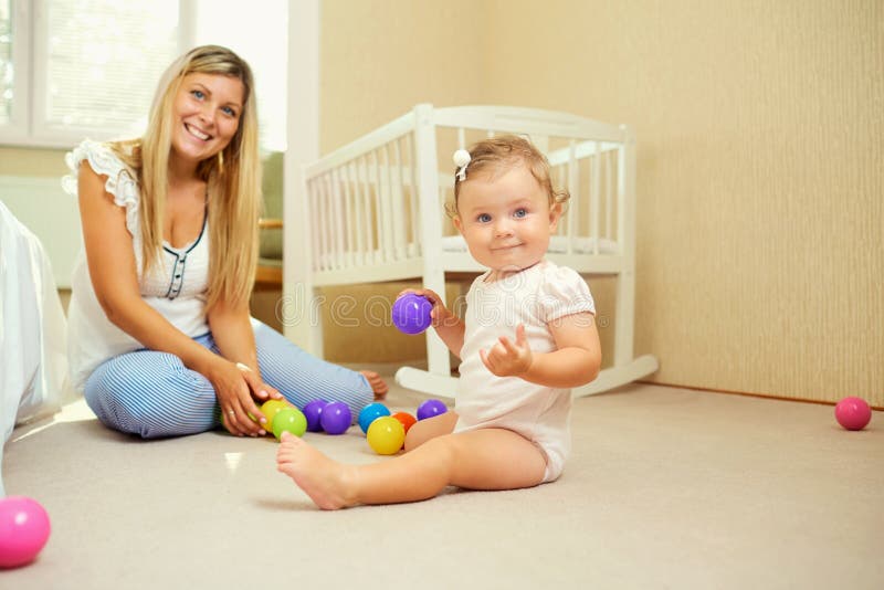 Mom Plays with the Baby in Room Indoors. Stock Image - Image of ...