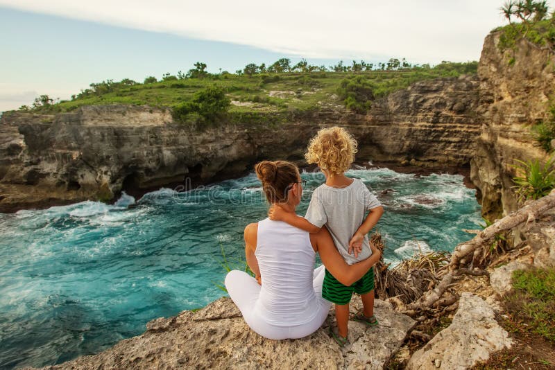 Mom with son by the ocean stock photo. Image of happy - 192364490