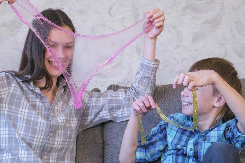 Mom and Son are Playing with Slime Sitting on the Sofa. Stock Photo ...