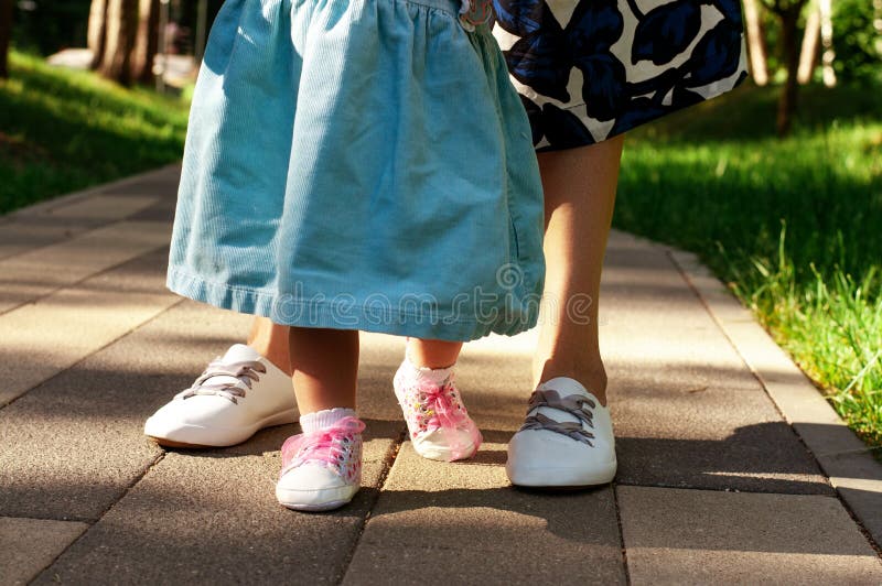Mom Teaches Daughter To Walk Summer Park Legs Closeup Mom With A One