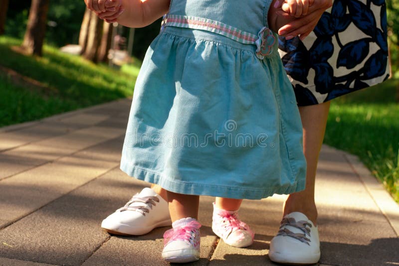 Mom Teaches Daughter To Walk Summer Park Legs Closeup Mom With A One