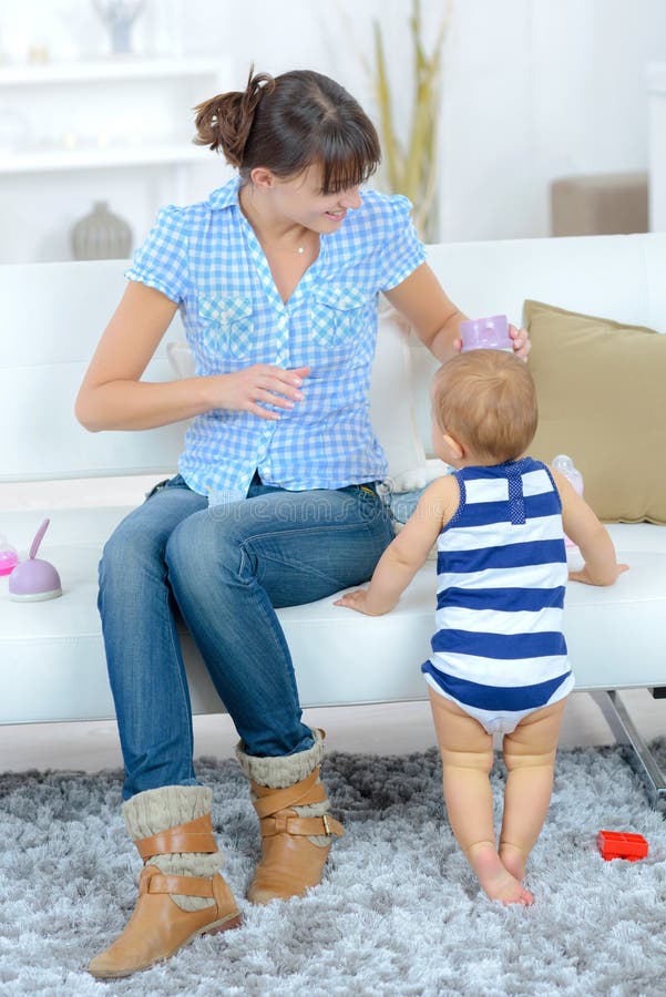 Mom teaching baby to walk stock photo. Image of mommy - 186134070