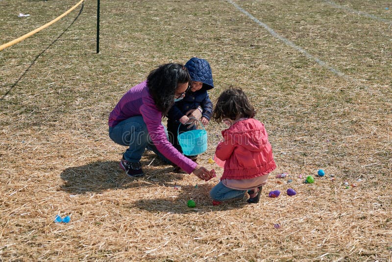 Kids with Mom are Searching for Easter Eggs during an Egg Hunt Stock Photo - Image of adorable ...