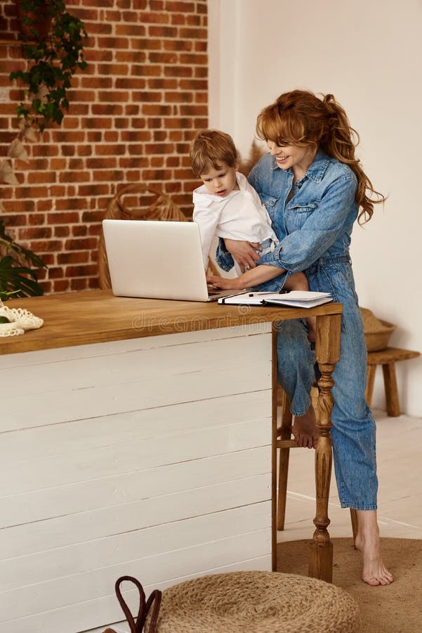 Mom works at the computer stock image. Image of home - 217041389