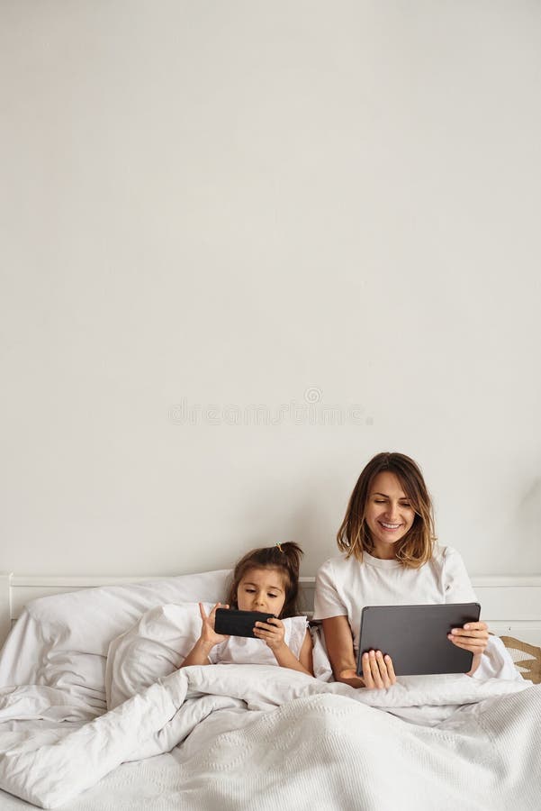 Mom Works at the Computer while Playing with Her Daughter Stock Photo ...