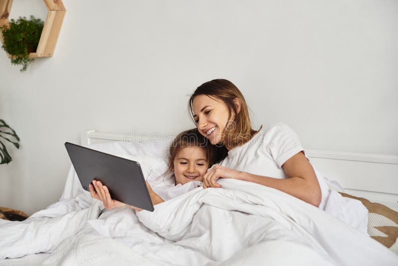 Mom Works at the Computer while Playing with Her Daughter Stock Photo ...