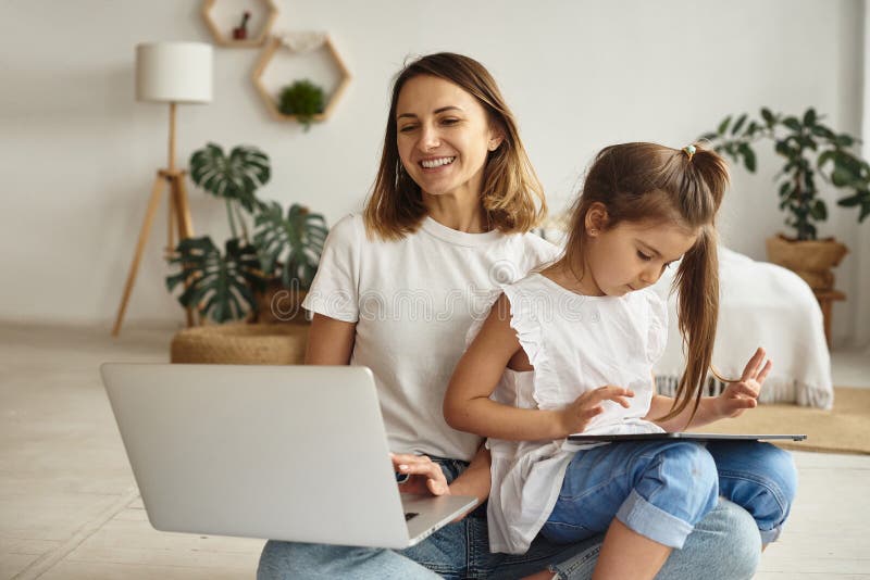 Mom Works at the Computer while Playing with Her Daughter Stock Image ...