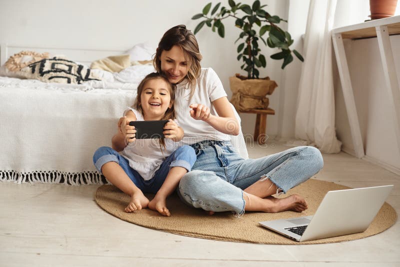 Mom Works at the Computer while Playing with Her Daughter Stock Photo ...