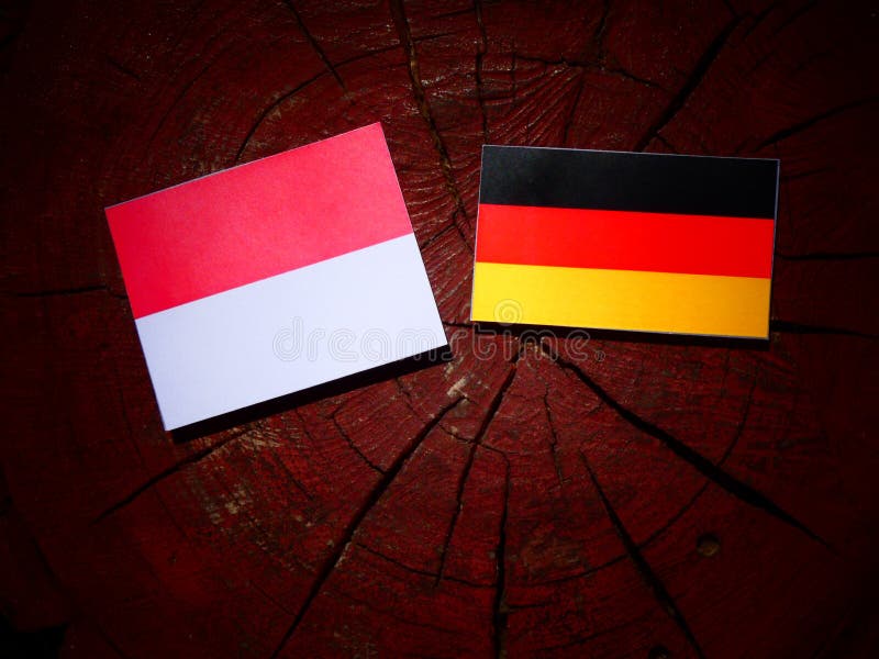 Monaco Flag with German Flag on a Tree Stump Stock Photo - Image of ...