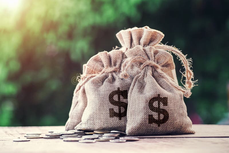 Money Bag on Wood with Coins Stack in Morning Light. Concept Saving ...