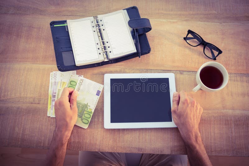 Money Bundle and Digital Tablet on the Table Stock Photo - Image of ...
