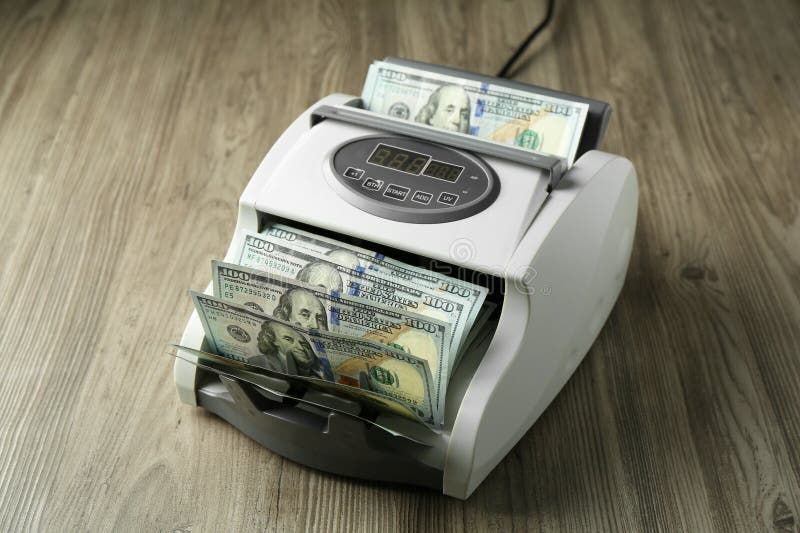 Money Counter Machine with Dollar Banknotes on Wooden Table Stock Photo ...