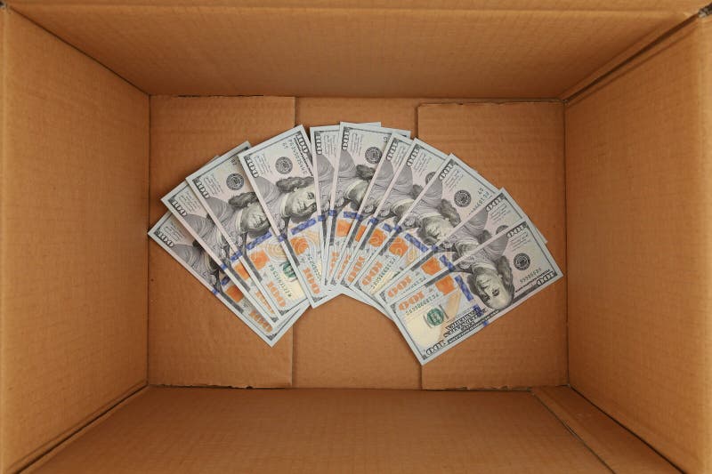 Money Dollars at the Bottom of a Cardboard Box Stock Image - Image of ...