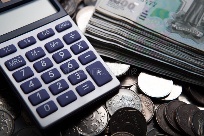 Money in the Form of Banknotes and Coins with Calculator Stock Photo ...