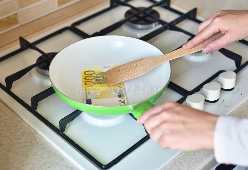 Money is fried in a pan stock photo. Image of concept - 187035514