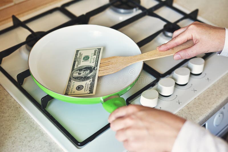 Money is fried in a pan stock photo. Image of banknote - 190848184