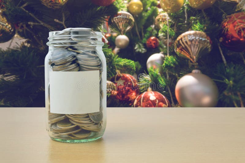 Money in the Glass Bottle with Decorated Christmas Tree Stock Photo ...