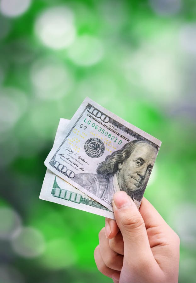 Money in Hand, Isolated on Green Background Stock Photo - Image of ...