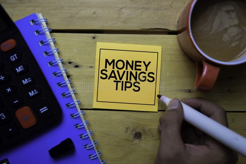 Money Savings Tips Write on Sticky Note with Wooden Table Background ...