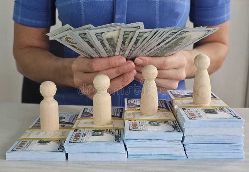 Money Stacking with Wooden Figures Representing Wealth Distribution and ...