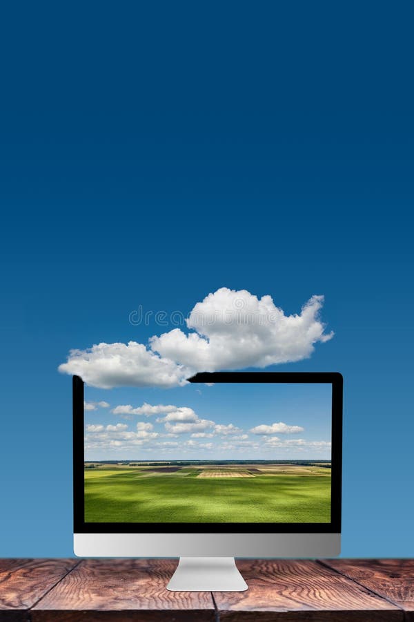 Monitor with Landscape on a Wooden Table and Blue Sky Background. Stock ...