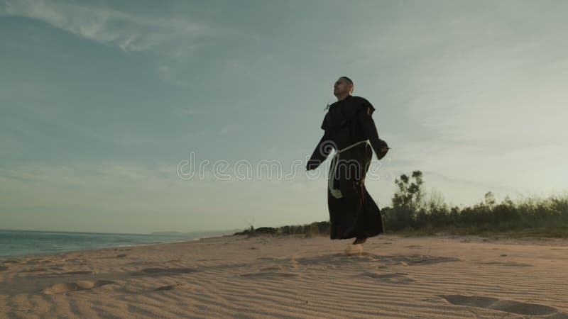 Religious Monk Concentrated in Prayer Kneeling on the Beach Alone Stock ...