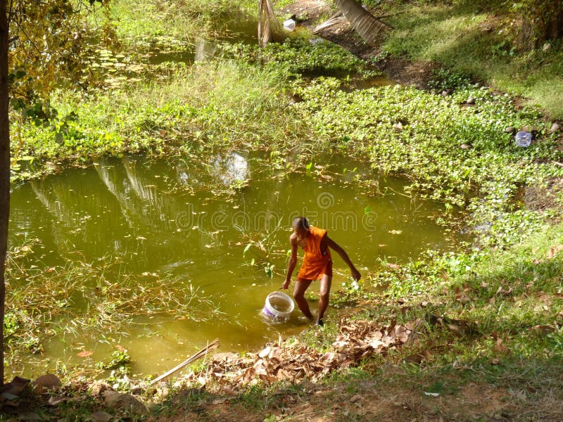 Monk fetching water editorial stock image. Image of pond - 45503959