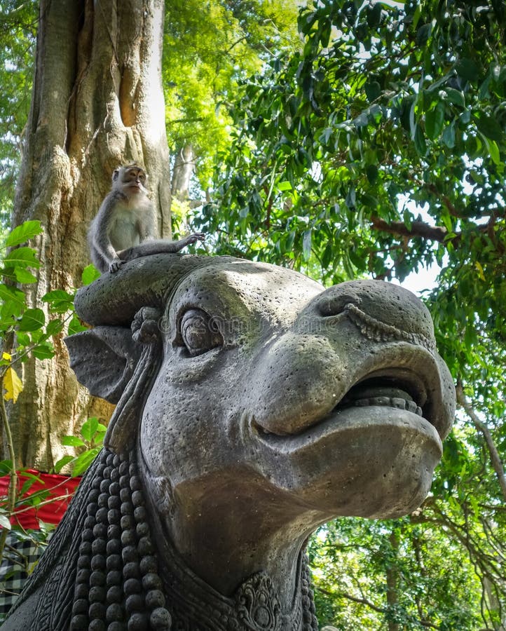 Monkey on a Cow Statue in the Monkey Forest, Ubud, Bali, Indonesia ...