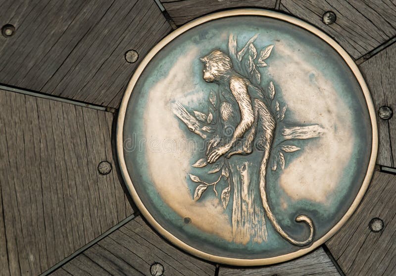 Monkey Metal Relief on Wood Floor Stock Photo - Image of metal ...