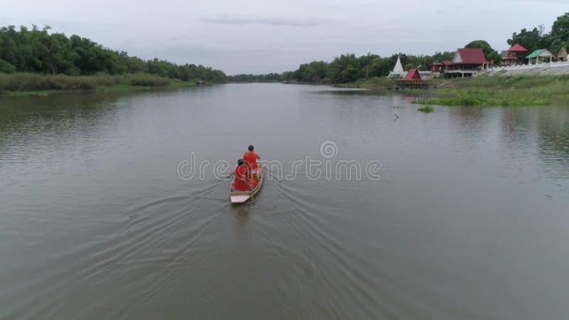 2 Monks Rowing Along the River To Receive Alms in the Morning. Stock ...