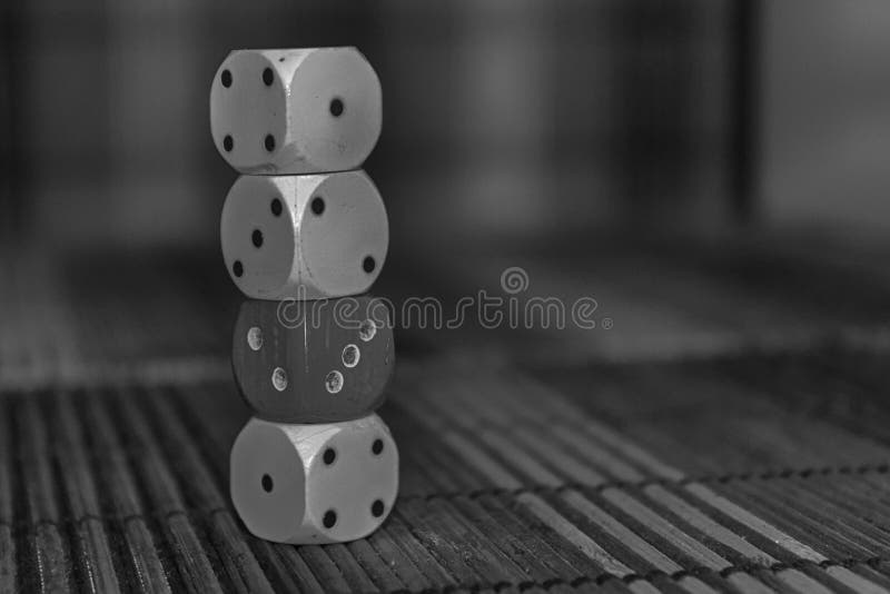 Monochrome Stack of Three Plastic Dices and One Dice on Wooden Board ...