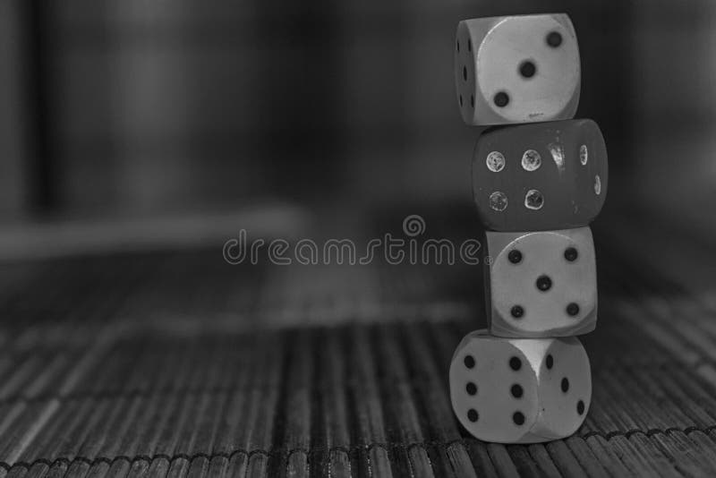 Monochrome Stack of Three Plastic Dices and One Dice on Wooden Board ...