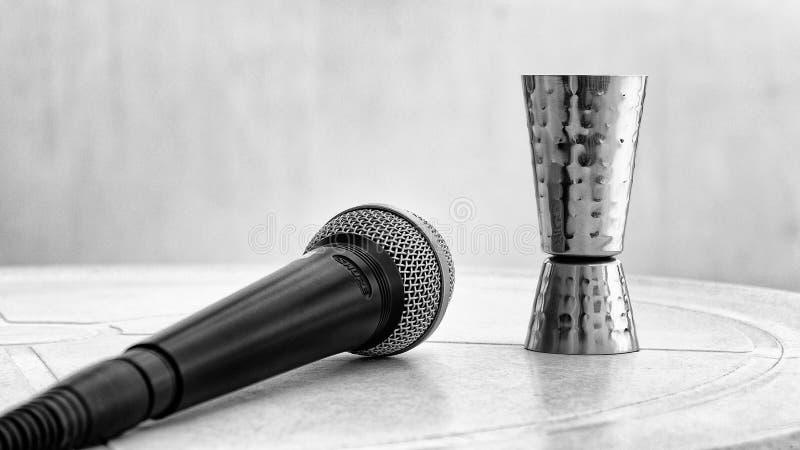 Still-life Shot of a Mic & Shot Glass Placed on a Table Stock Photo ...