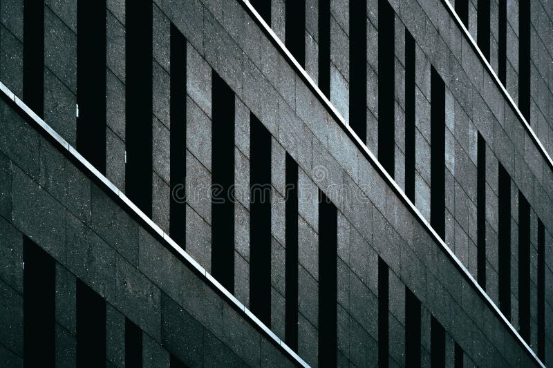 Monolithic Dark Building with Vertical Slits Creating a Dramatic Rhythm ...
