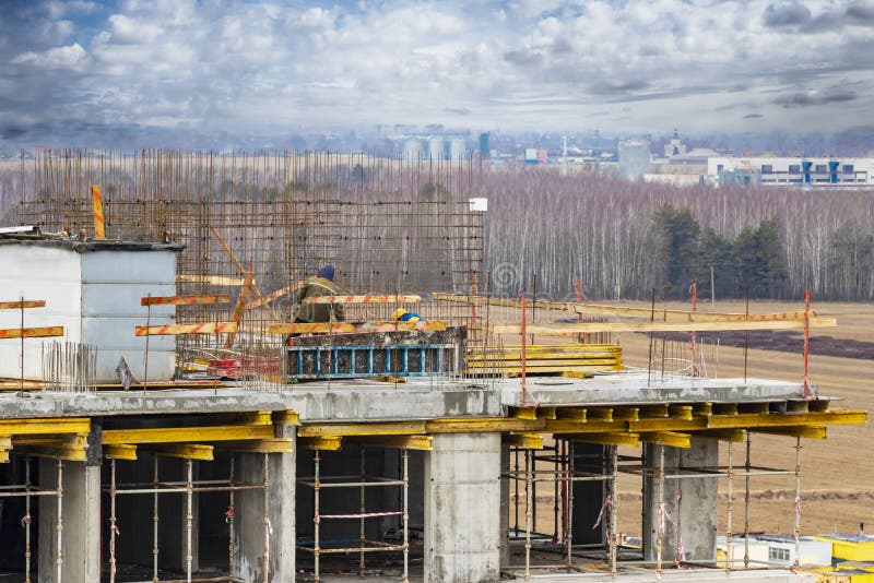 Monolithic Frame Construction of the Building. Workers Working at the ...