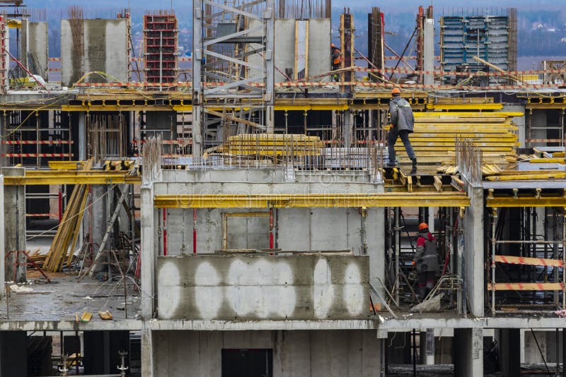 Monolithic Frame Construction of the Building. Workers Working at the ...