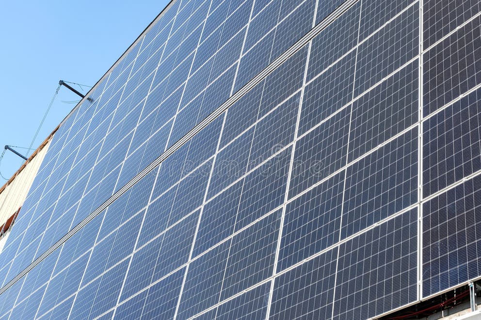 Montage of a Large Array of Solar Panels on the Side of a Building ...