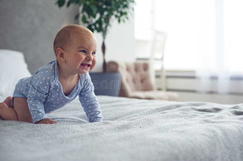 8 Month Old Happy Baby Boy Crawling on Bed at Home Stock Image - Image ...